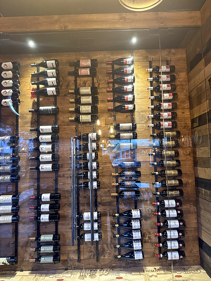 Wine bottles standing at attention like soldiers guarding flavor. This isn't just storage&mdash;it's a wall of liquid possibilities.