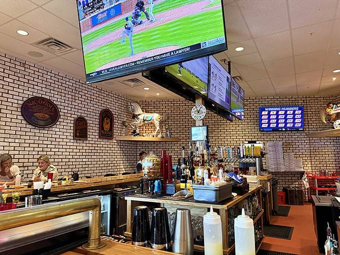 This bar area proves that sometimes the best atmosphere comes with TVs, cold drinks, and zero pretense.
