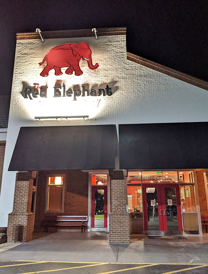 The illuminated sign guides hungry diners toward consistently excellent pizza experiences every single night.