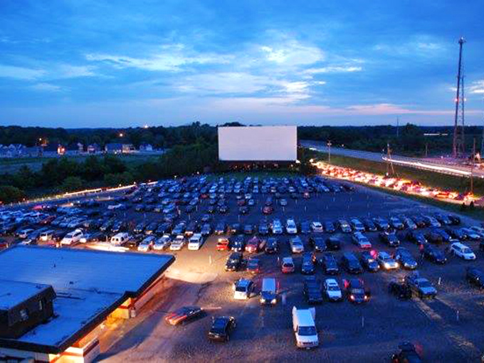 As twilight deepens, headlights create light rivers flowing through the lot&mdash;each car a private theater with the best seats in the house.