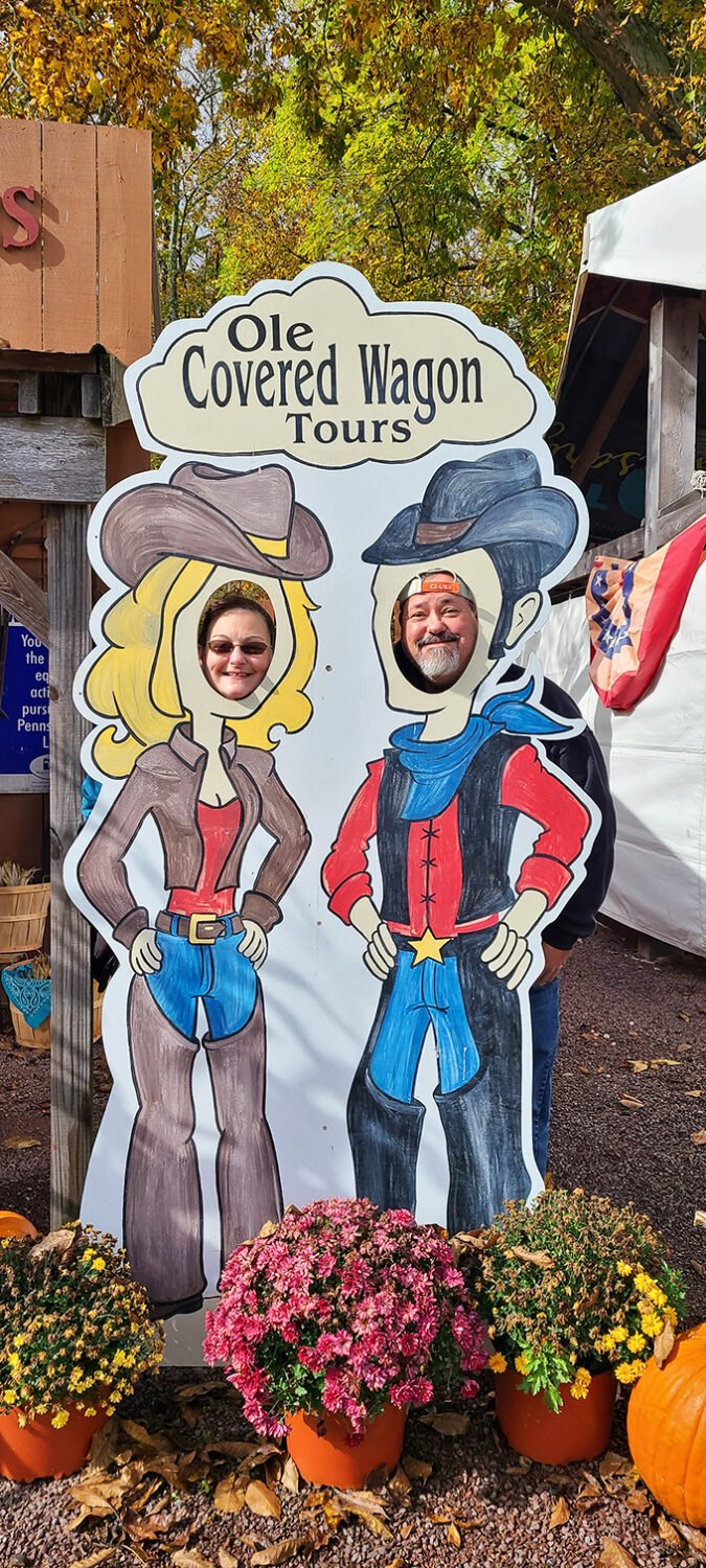 The photo cutout board adds a touch of whimsy to the authentic experience, inviting visitors to literally put themselves in a pioneer's boots.