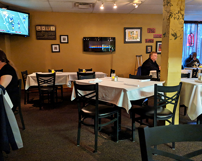 Warm lighting transforms simple tables into intimate dining spaces. The restaurant's golden glow makes everyone look like they're starring in their own food memoir.