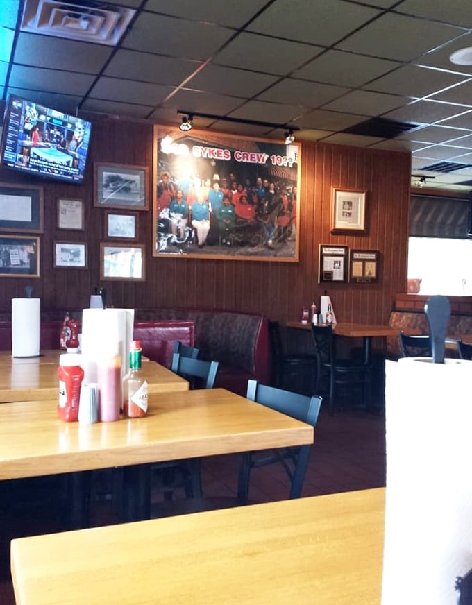 Wood paneling and memorabilia tell stories of BBQ triumphs past. Every photo frame holds a chapter of smoke-ringed history.