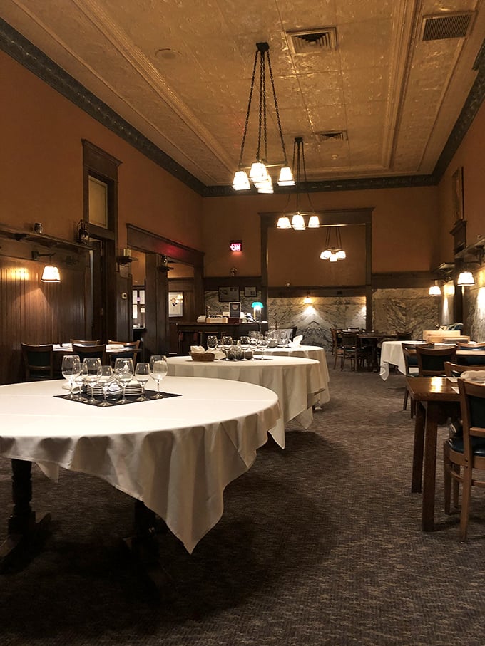 White tablecloths signal serious dining intentions, while the warm lighting and historic details remind you that memorable meals aren't just about the food.