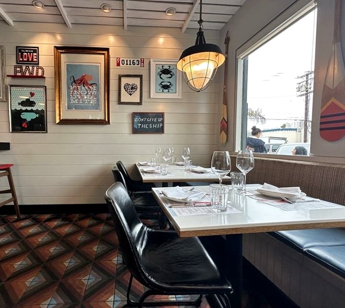 Nautical-inspired wall art that says "we're serious about seafood without being serious about ourselves." That "Don't Give Up The Ship" sign speaks to my soul.