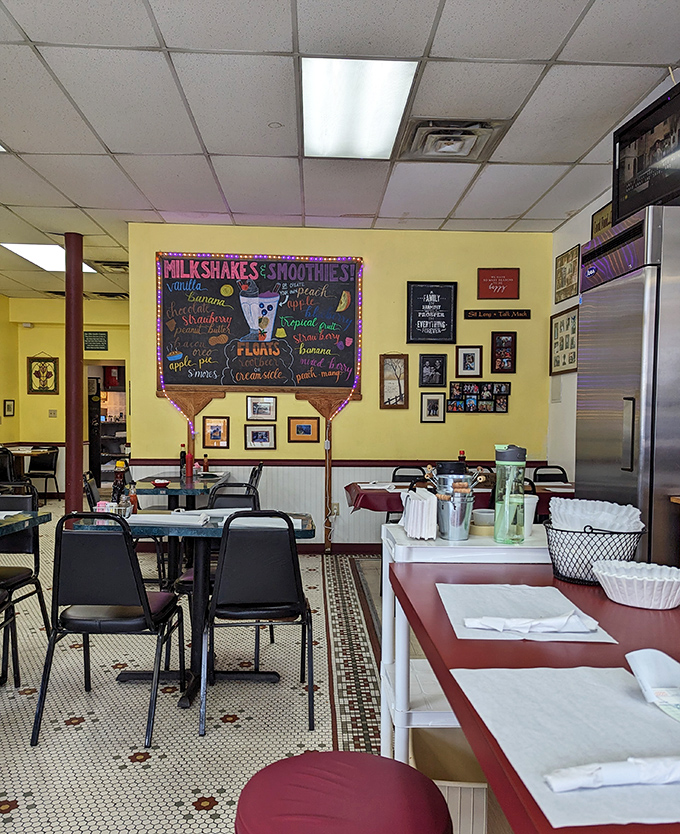 The milkshake menu board promises liquid happiness in flavors from classic to adventurous. Those black chairs have heard decades of Pittsburgh stories.