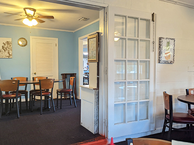 Peek through the French doors and you'll find a dining room that prioritizes comfort over Instagram aesthetics. Your focus belongs on the plate anyway.