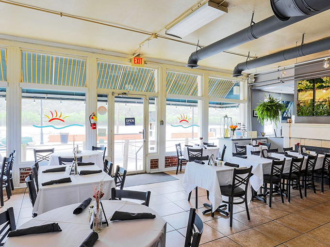 Sunlight streams through windows in this bright, airy dining space where every table feels like the best seat in the house.