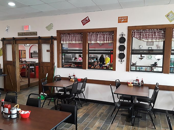 Simple tables, checkered curtains, and sliding barn doors &ndash; a dining room that feels like your favorite aunt's kitchen, only with better food.