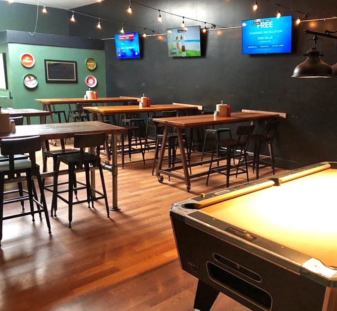 High-top tables and TVs create that perfect sports bar atmosphere where strangers become friends over shared victories and defeats.