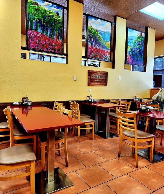 Vibrant landscape paintings bring Florida's natural beauty indoors, complementing the warm wooden chairs and terra cotta floors.