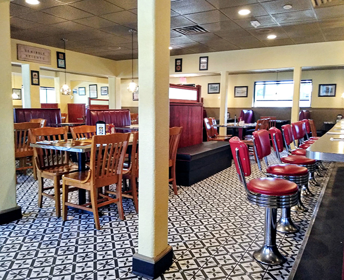 The dining room's pattern of burgundy booths and wooden tables creates that perfect balance of comfort and classic diner aesthetic.