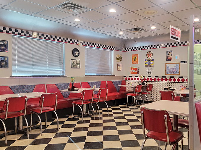 Red booths invite you to slide in and stay awhile. The checkered pattern isn't just on the floor&mdash;it's the rhythm of diner life itself.