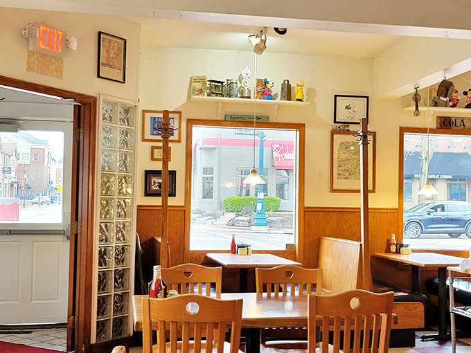 Sunlight streams through windows framing a view of small-town America, while wooden chairs invite you to stay just a little longer.