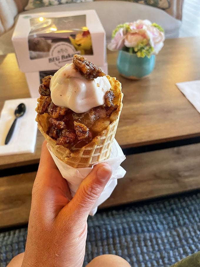 Apple pie in ice cream form, held by a hand that clearly knows good decisions. The waffle cone is just showing off at this point.