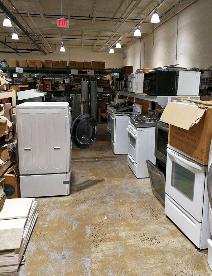 Appliance alley: where slightly used refrigerators and stoves stand at attention, ready to serve in your kitchen for years to come.