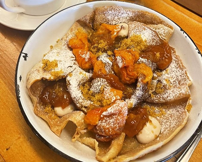 A sweet crepe that's dressed for success with apricot compote and powdered sugar&mdash;proof that plant-based desserts can be both elegant and indulgent.