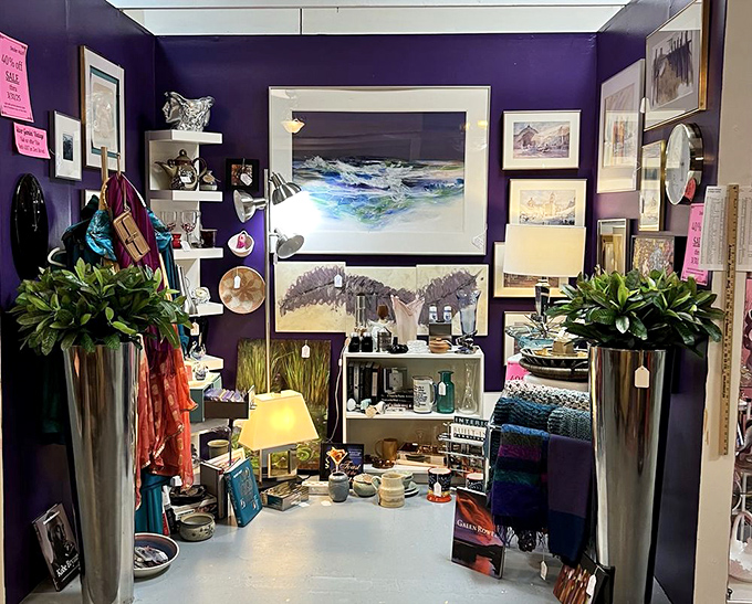 A purple-walled sanctuary of artistic expression. This booth curator understands that sometimes the frame is as important as what's inside it.