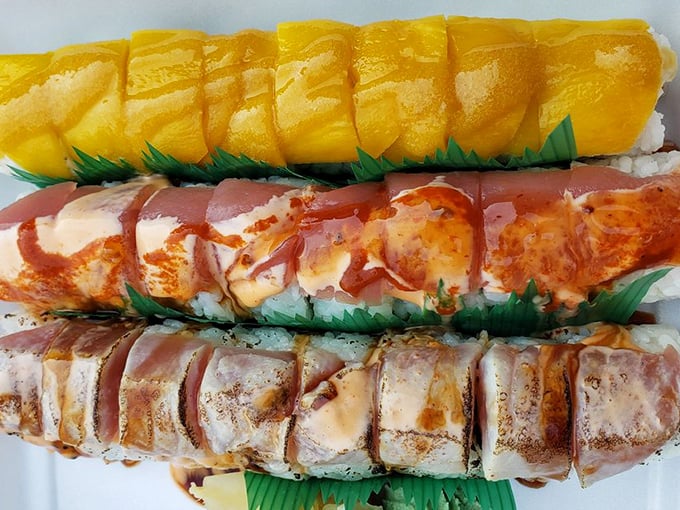 Three distinct rolls showcasing the rainbow of flavors possible when rice meets fish meets the hands of someone who knows what they're doing.