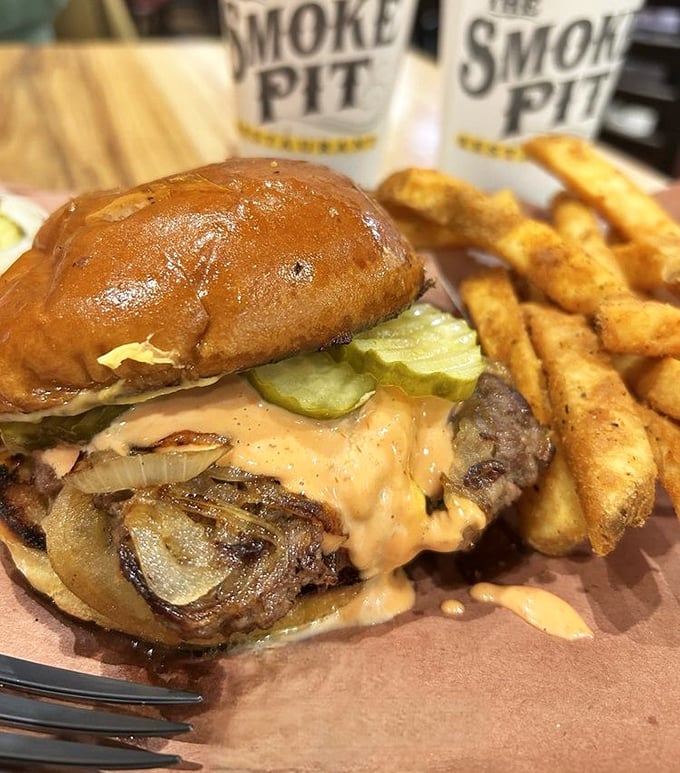 The burger that makes you question everything you thought you knew about barbecue joints. Those seasoned fries are the perfect supporting cast.