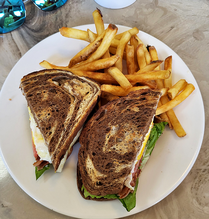 A sandwich that understands the assignment &ndash; perfectly toasted bread, crisp lettuce, and that added fried egg that transforms good into unforgettable.