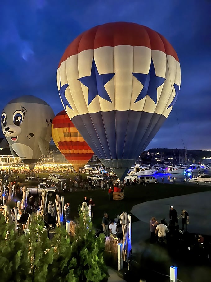 Hot air balloons illuminate the twilight sky, transforming an ordinary evening into a technicolor spectacle over the harbor.