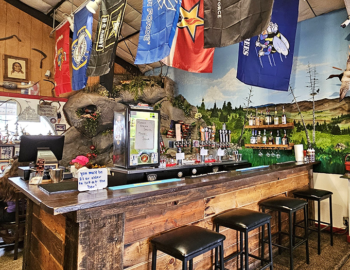 The rustic bar area, backed by that stunning landscape mural, offers a perfect perch to contemplate your next BBQ selection.