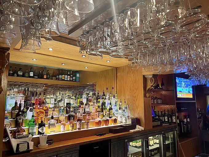 The bar at Angelo's isn't just well-stocked – it's a shrine to libations, where perfectly mixed cocktails complement those legendary steaks.