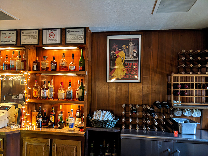 A well-stocked bar area with vintage Italian posters &ndash; because great food deserves equally great atmosphere.