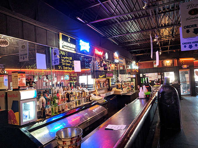 The bar glows with neon promises of cold beer and good times, a beacon for salty dogs and landlubbers alike after a day in the Florida sun.