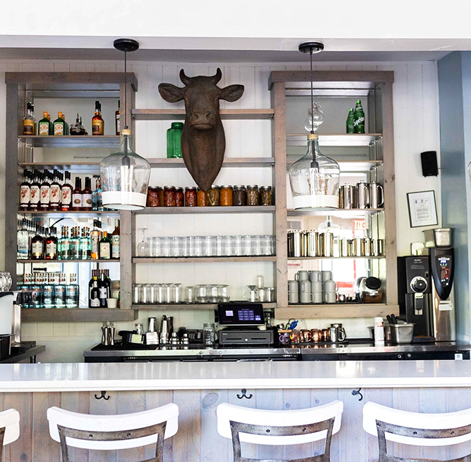 The bar setup that says "yes, breakfast cocktails are absolutely appropriate." That cow head silently judges those who disagree.