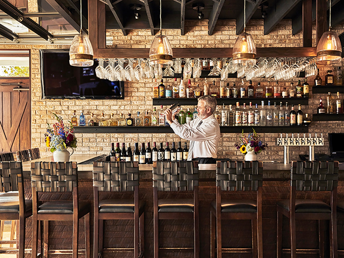 The bar area doesn't just serve drinks&mdash;it serves possibilities, all lined up in bottles against that gorgeous exposed brick backdrop.