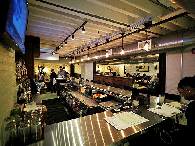 The bar area hums with the energy of a place where regulars and first-timers mingle easily. Those pendant lights cast the kind of glow that makes everyone look their best.