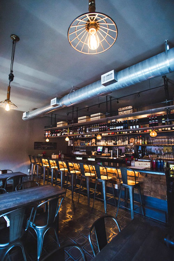 Not just a bar, but a liquid library of Italian spirits. Those pendant lights create the perfect glow for making evening decisions.