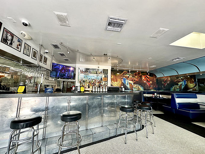 The bar area gleams with promise, where classic cocktails meet diner charm. James Dean would approve of this stylish corner.