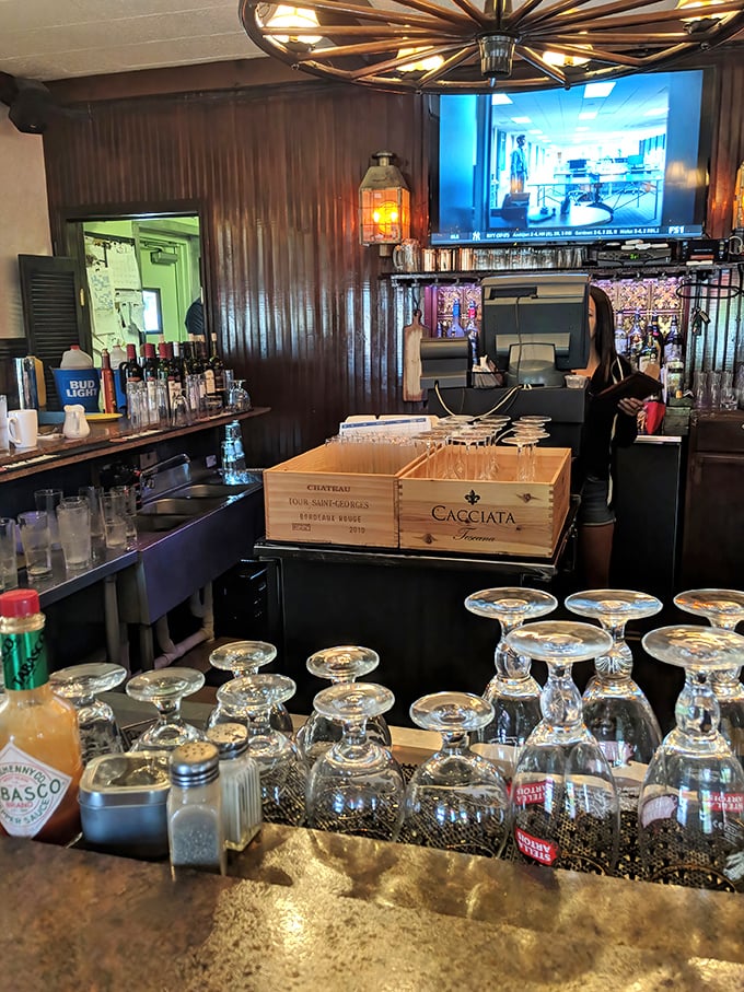 Behind every great tavern is a bar area that feels like it's been waiting just for you, complete with upside-down wine glasses.