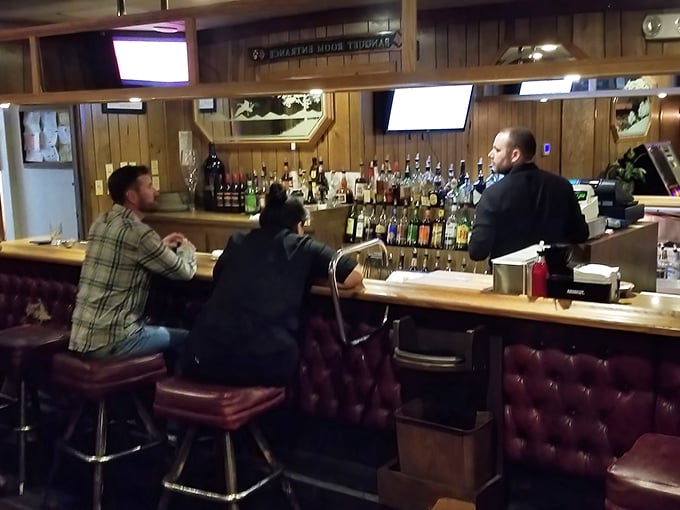 The bar: where solo diners find community, couples have first dates, and locals debate everything except the quality of The Broiler's steaks.