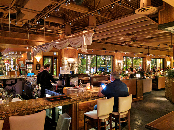 The bar area – where strangers become friends and "I'll just have one drink" becomes a delightful evening of culinary exploration.