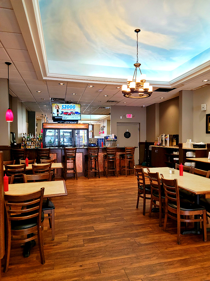 The bar area offers a glimpse into Cambridge social life, where wood tones and warm lighting create the perfect backdrop for local stories.