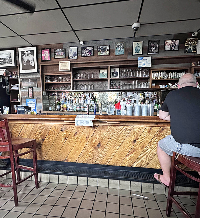The wooden bar, worn smooth by decades of elbows and stories, showcases Philadelphia sports memorabilia that chronicles the city's passionate relationship with its teams.