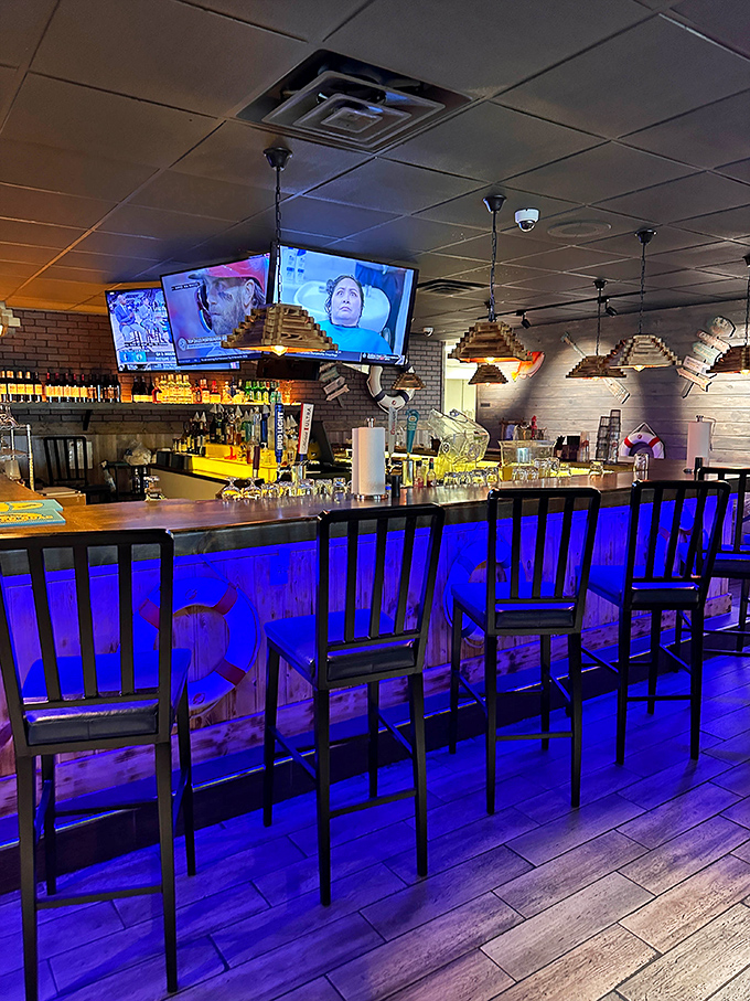 The bar glows with an otherworldly blue light, as if signaling to thirsty sailors that refreshment awaits after their seafood conquest.