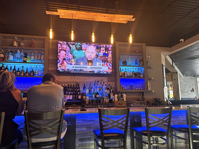 The bar at Mussel Beach isn't just serving drinks; it's offering front-row seats to the liquid side of culinary artistry. Blue lighting adds underwater vibes.