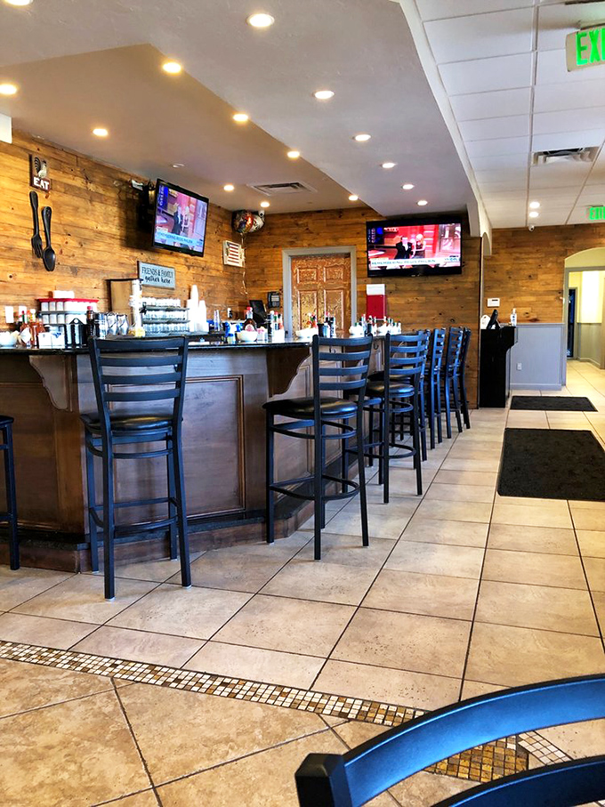 The bar area where morning coffee transforms into afternoon conversations, complete with TVs for sports debate fuel.