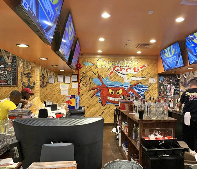 The bar area glows with promise, where cold beers and cocktails stand ready to cool the heat of Cajun spices in the most delightful way.