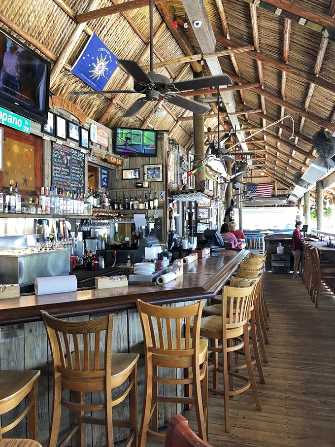 The thatched-roof bar with its weathered wood and ceiling fans captures Old Florida's soul. Hemingway would feel right at home here.