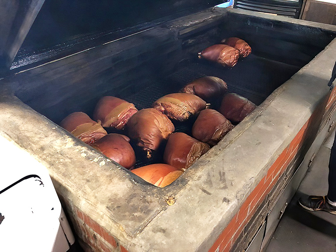 These glistening hunks of pork shoulder aren't just meat – they're future memories being crafted in the sacred pit.