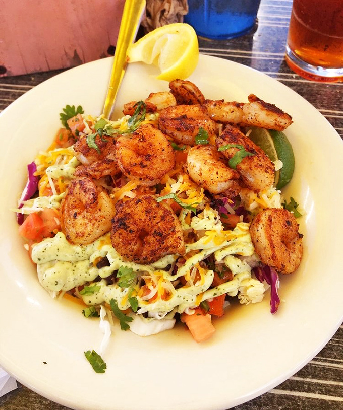 "Blackened shrimp perched atop a colorful salad &ndash; proof that 'eating healthy' and 'absolutely delicious' aren't mutually exclusive concepts."