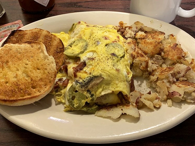 An omelet that's had a proper introduction to vegetables, nestled beside golden home fries. The breakfast trinity completed with perfectly toasted English muffin.