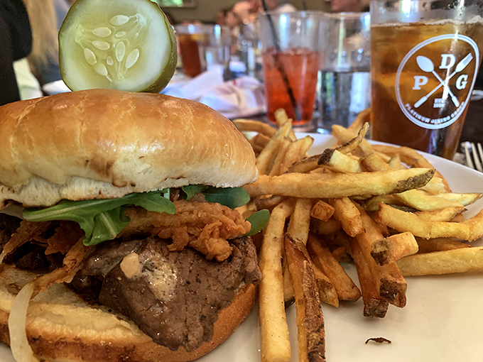 The burger that launched a thousand road trips, with fries so golden they'd make Fort Knox jealous. That pickle slice is just showing off.