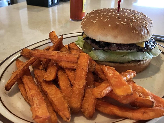 The classic burger and sweet potato fries combo—proof that simplicity, when done right, needs no improvement. American poetry on a plate.